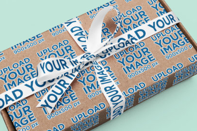 Placeit - Mockup of a Box With a Ribbon Placed on a Colorful Surface
