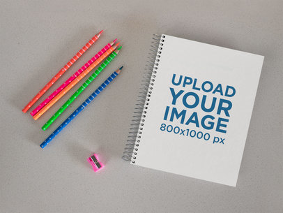 Placeit - Mockup of a Notebook Placed on a Dressmaker's Table