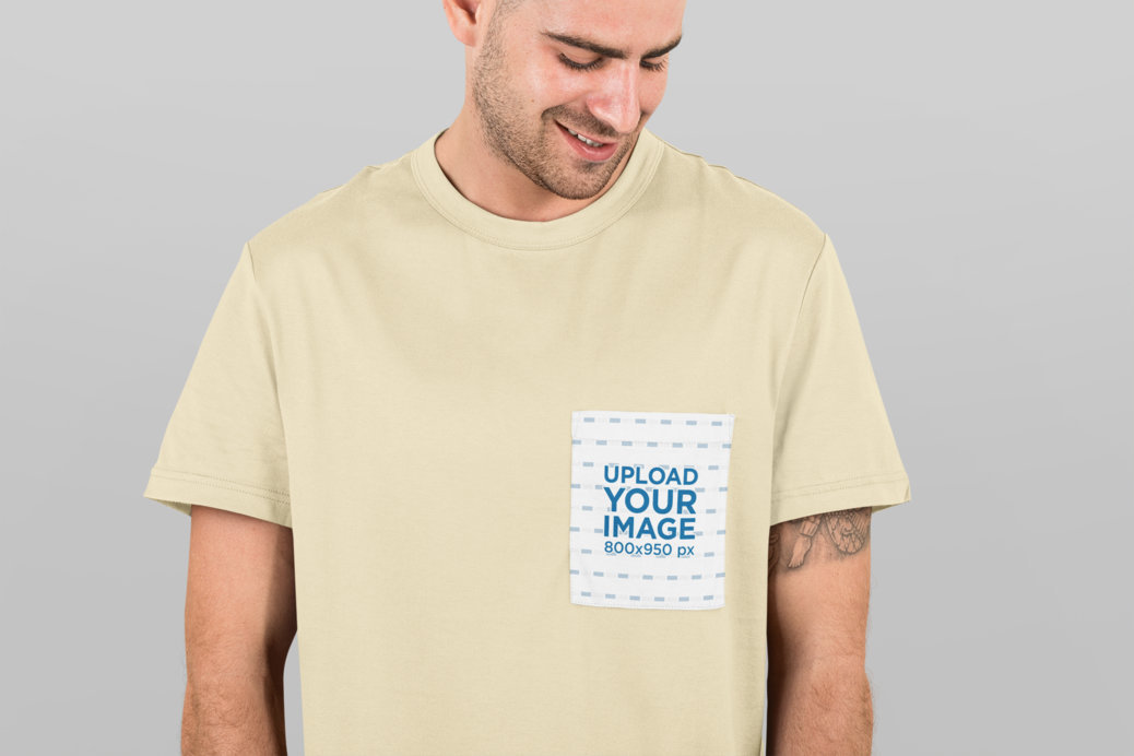 Placeit - Mockup of a Tattooed Man Wearing a Pocket Tee in the Studio
