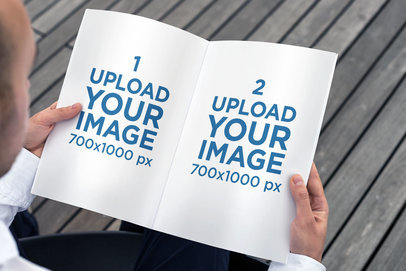Placeit - Mockup of a Man Reading a Magazine on a Desk